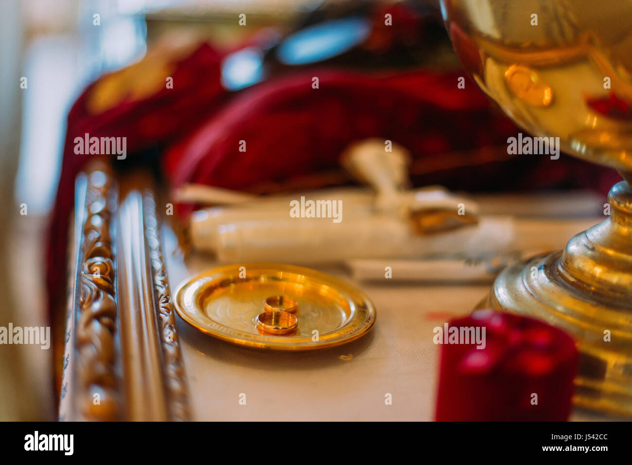 Two golden wedding rings in ceremonial bown on church altar Stock Photo ...