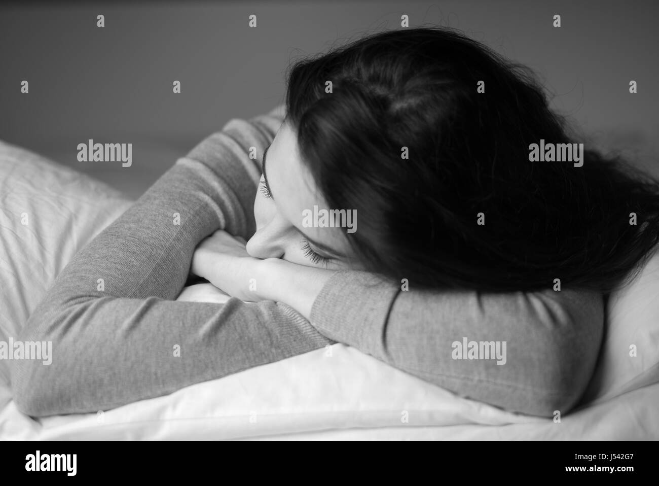 Young woman relaxing and sleeping in the bedroom, she is lying down on ...