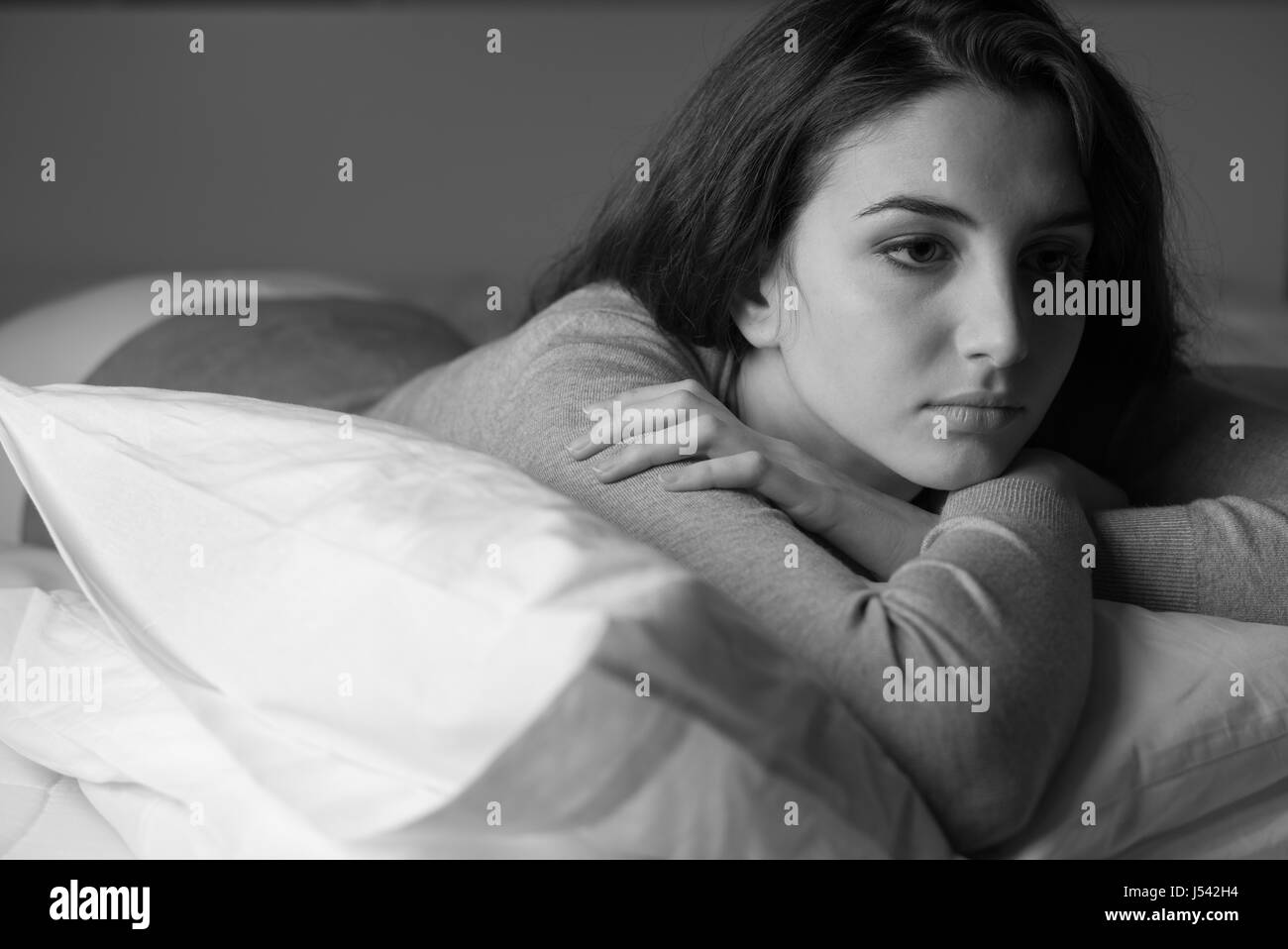 Woman on bed sad Black and White Stock Photos & Images - Alamy