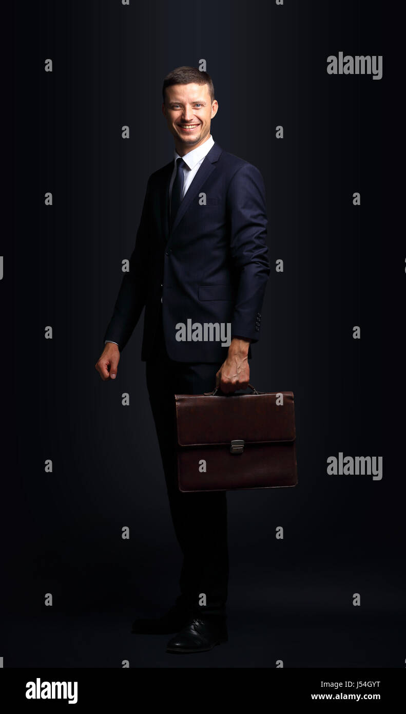 Portrait of a handsome business man with briefcase isolated on Stock ...