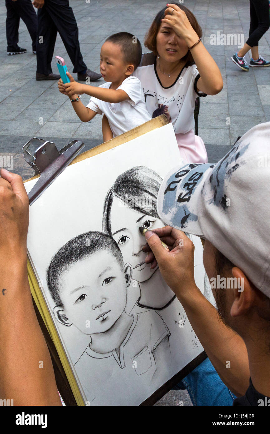 Chinese street artist drawing a portrait, Yinchuan, Ningxia, China ...