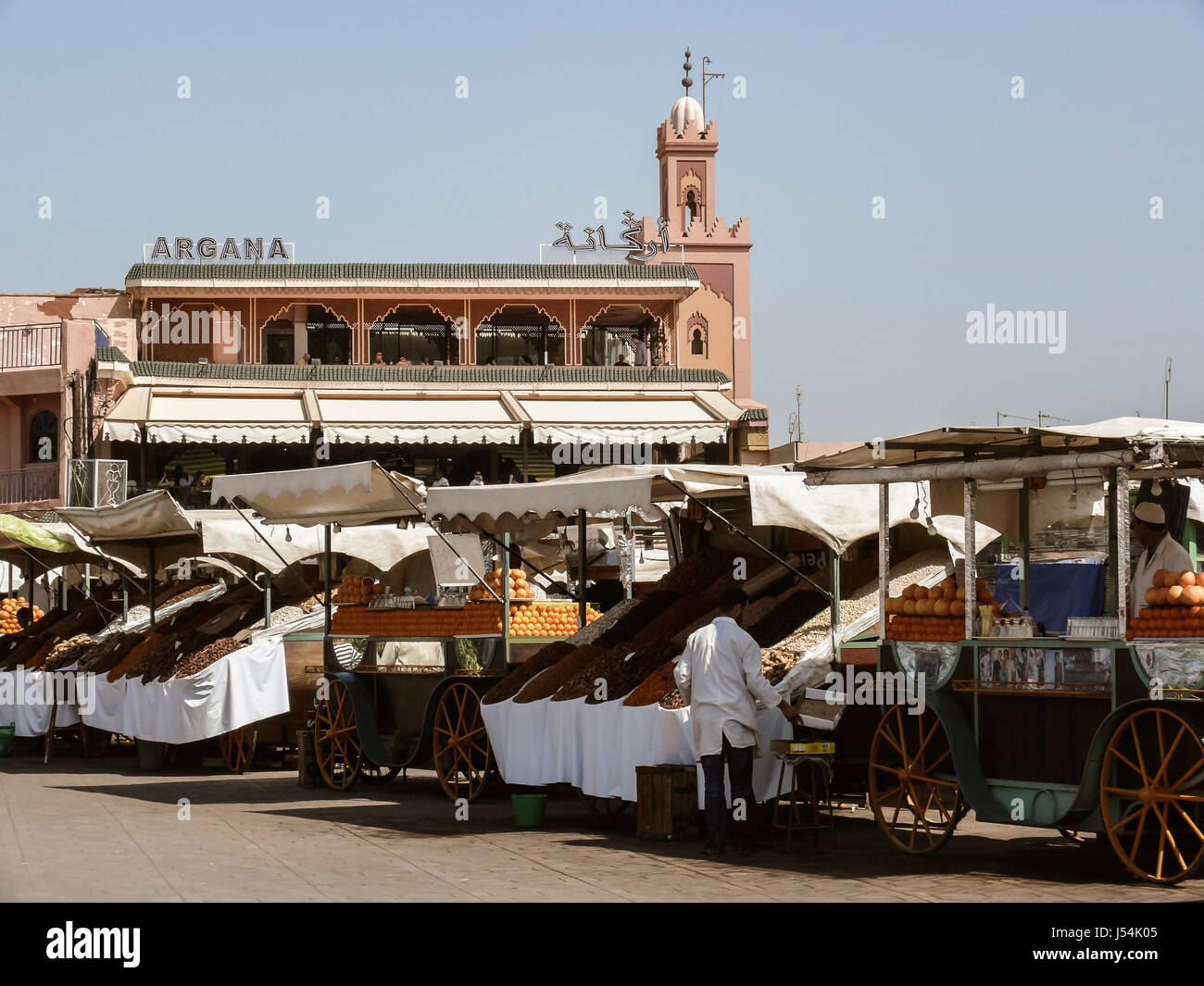 Orange juice stall, and nut and fruit vendors in front of Café Argana ...