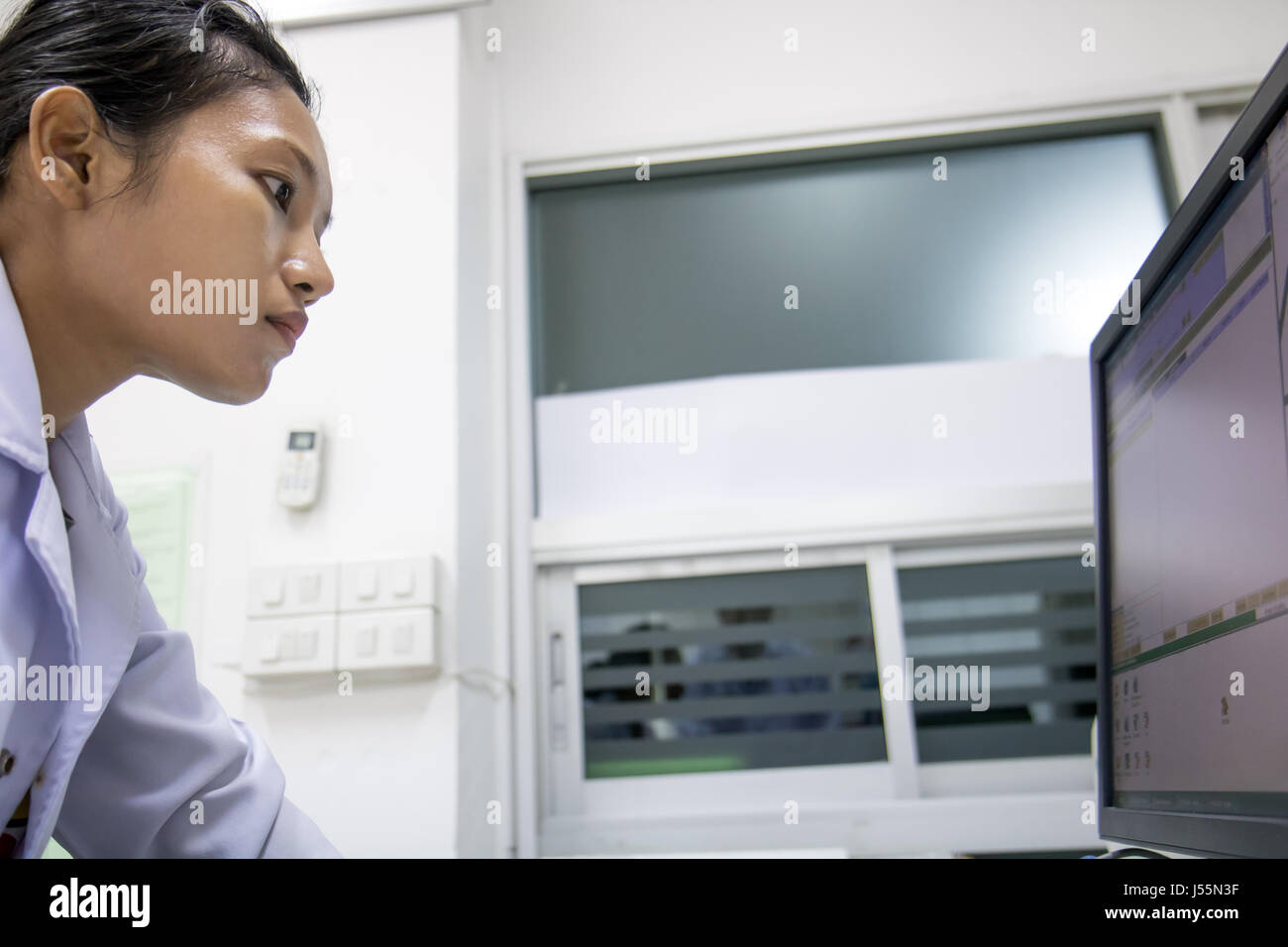 Medical staff checks registration on computer display. Night shifts ...
