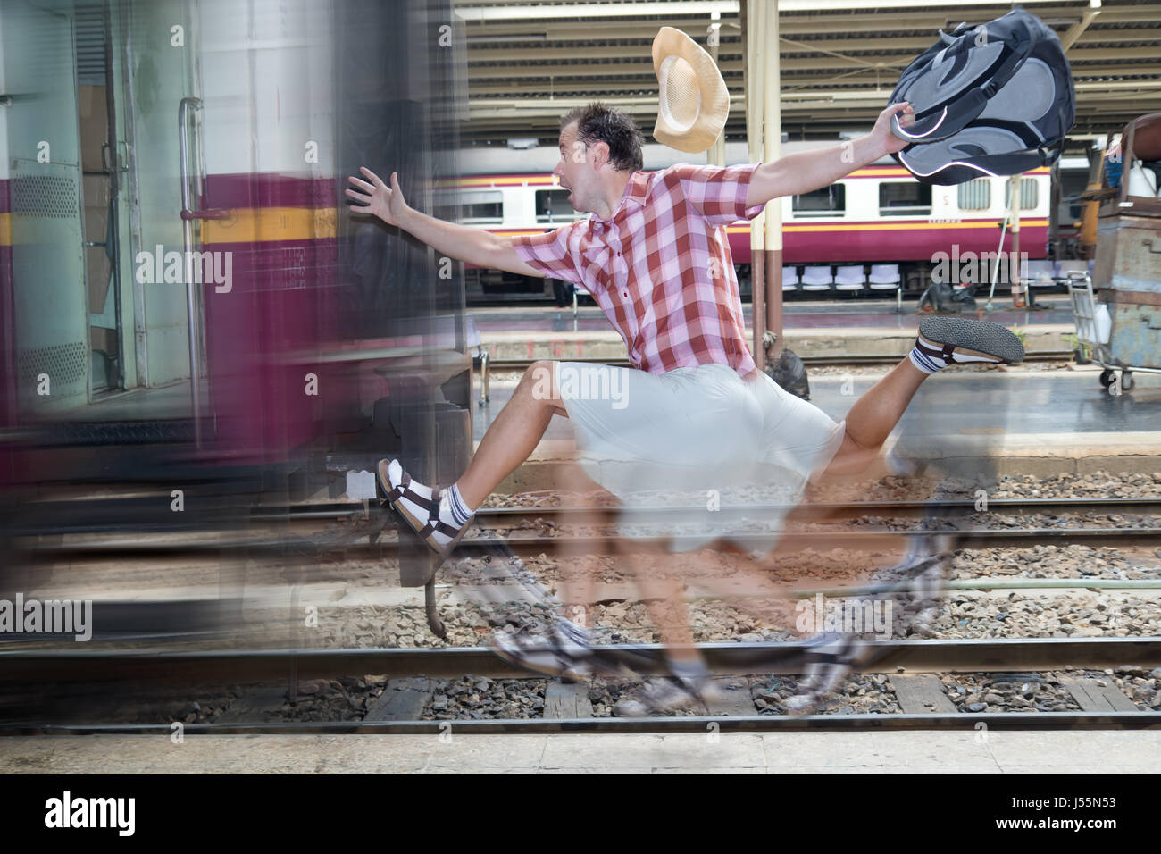 Tourist with bag running behind the train. A man runs for a moving ...
