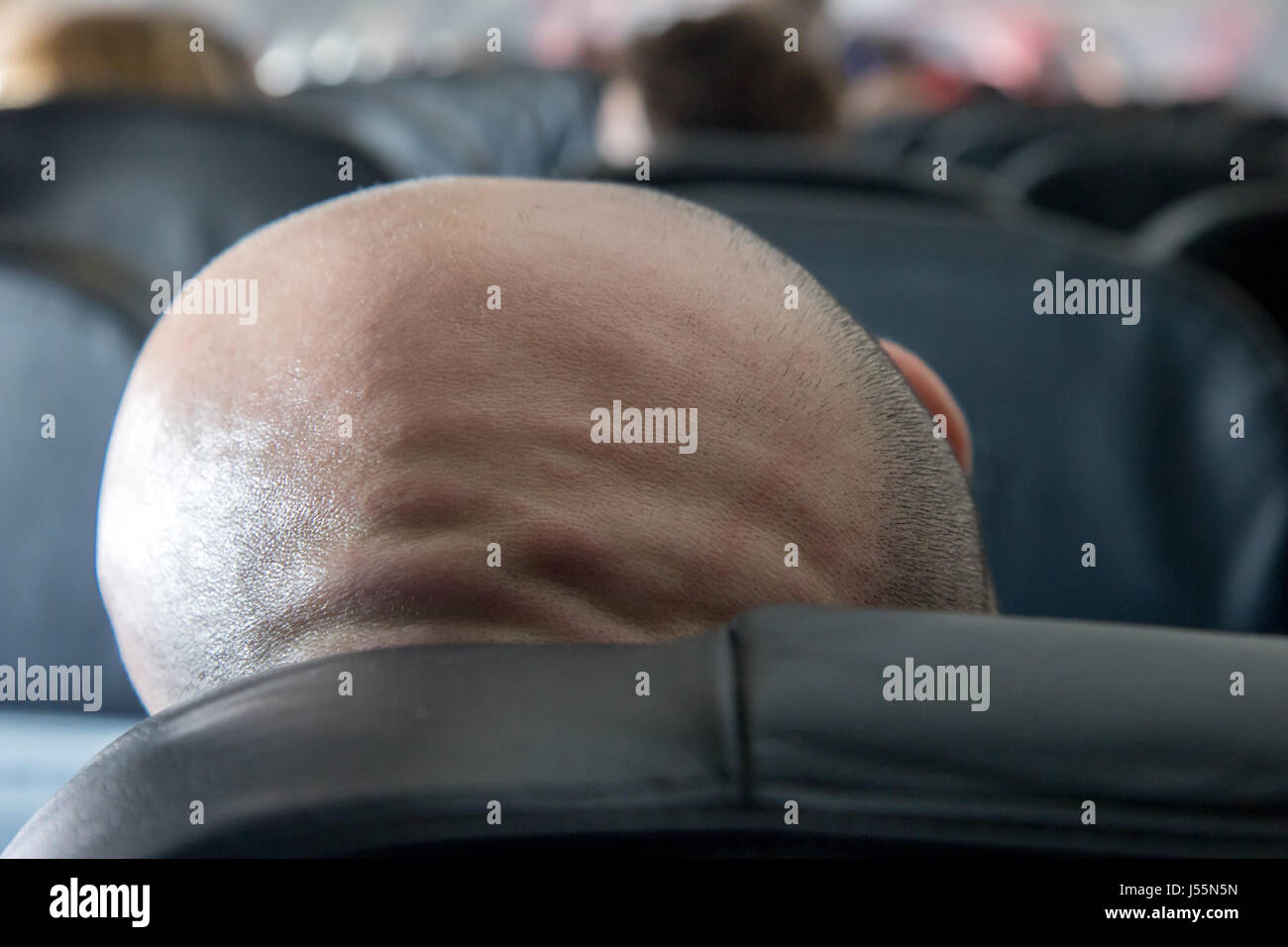 Bald man sleeping on the plane. Bald passenger resting in flying ...