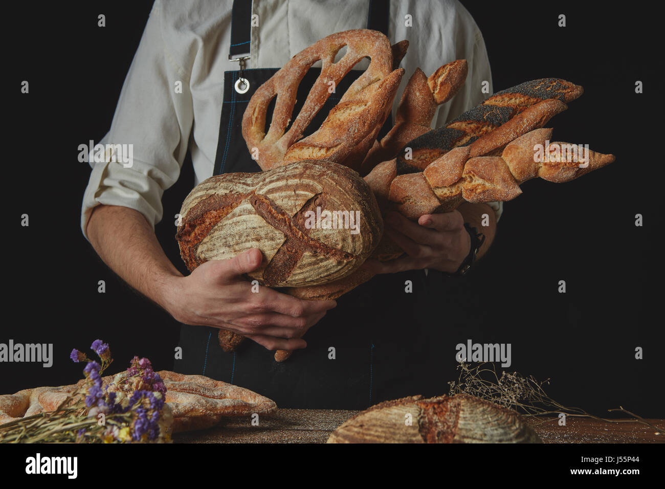 Variety of bread hold men's hands Stock Photo - Alamy
