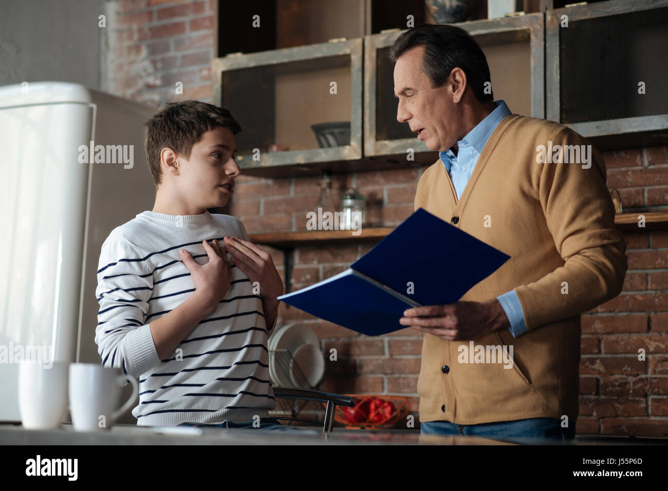 Attractive pupil explaining his point of view Stock Photo - Alamy