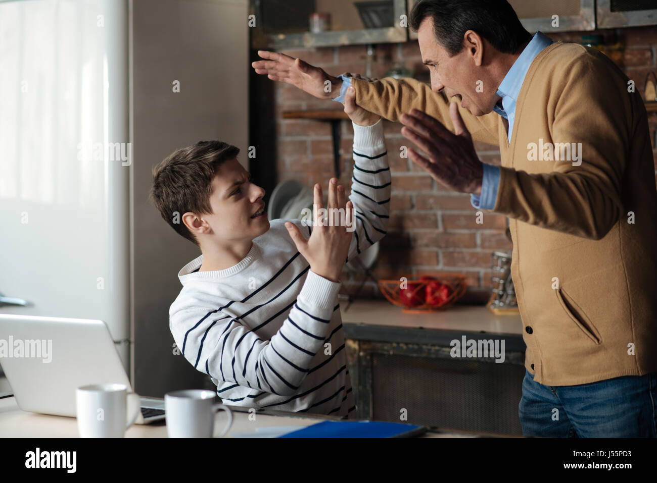 Disappointed boy arguing with his father Stock Photo - Alamy