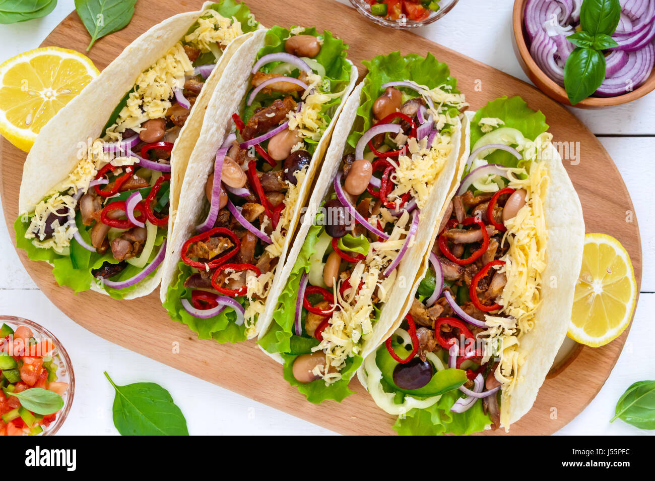 Tacos is a traditional Mexican dish. Tortilla stuffed with chicken ...