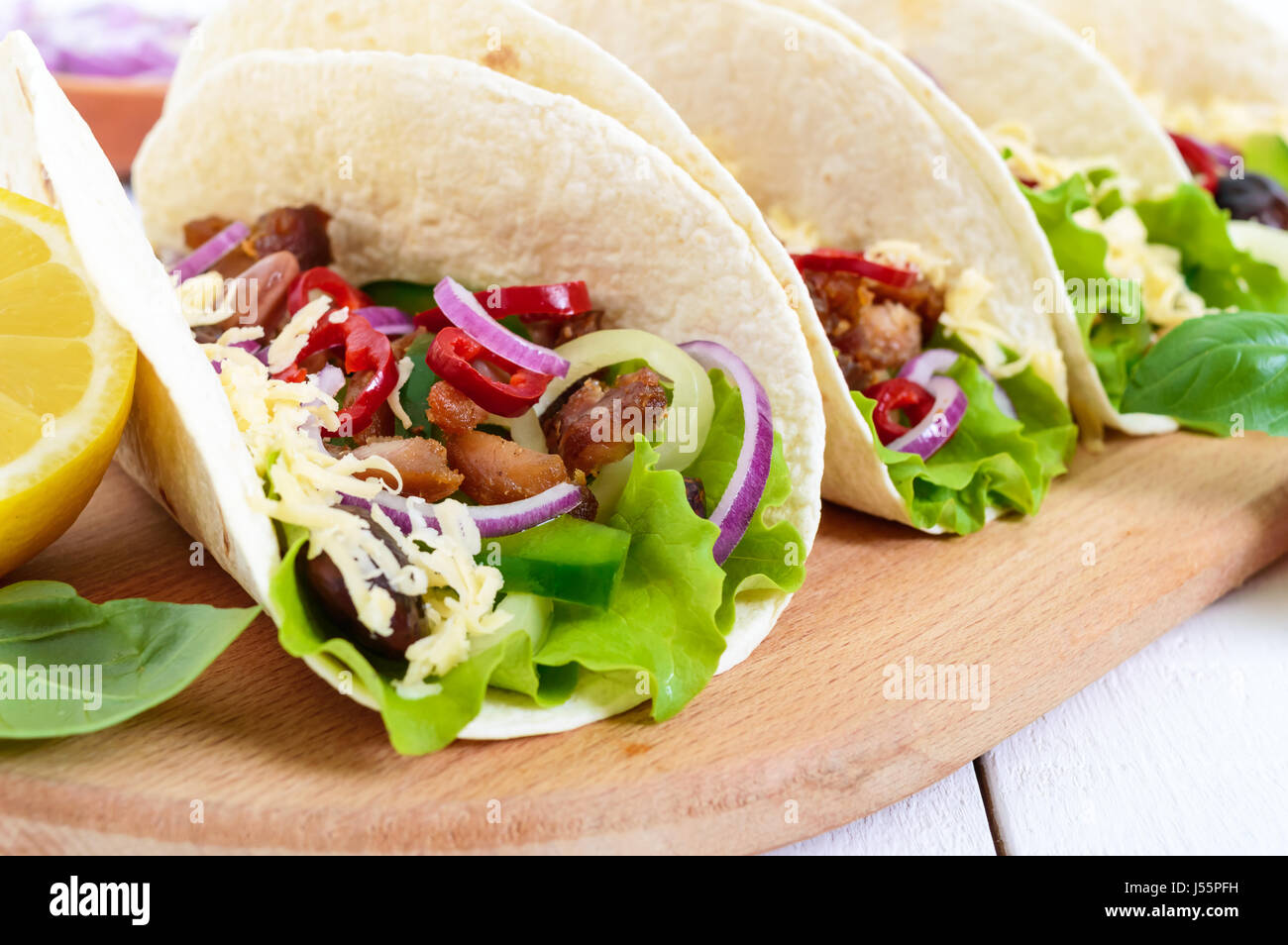 Tacos is a traditional Mexican dish. Tortilla stuffed with chicken ...