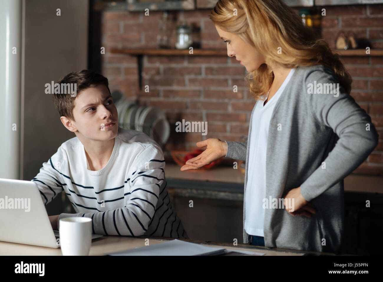 Attentive boy looking at his mother Stock Photo - Alamy