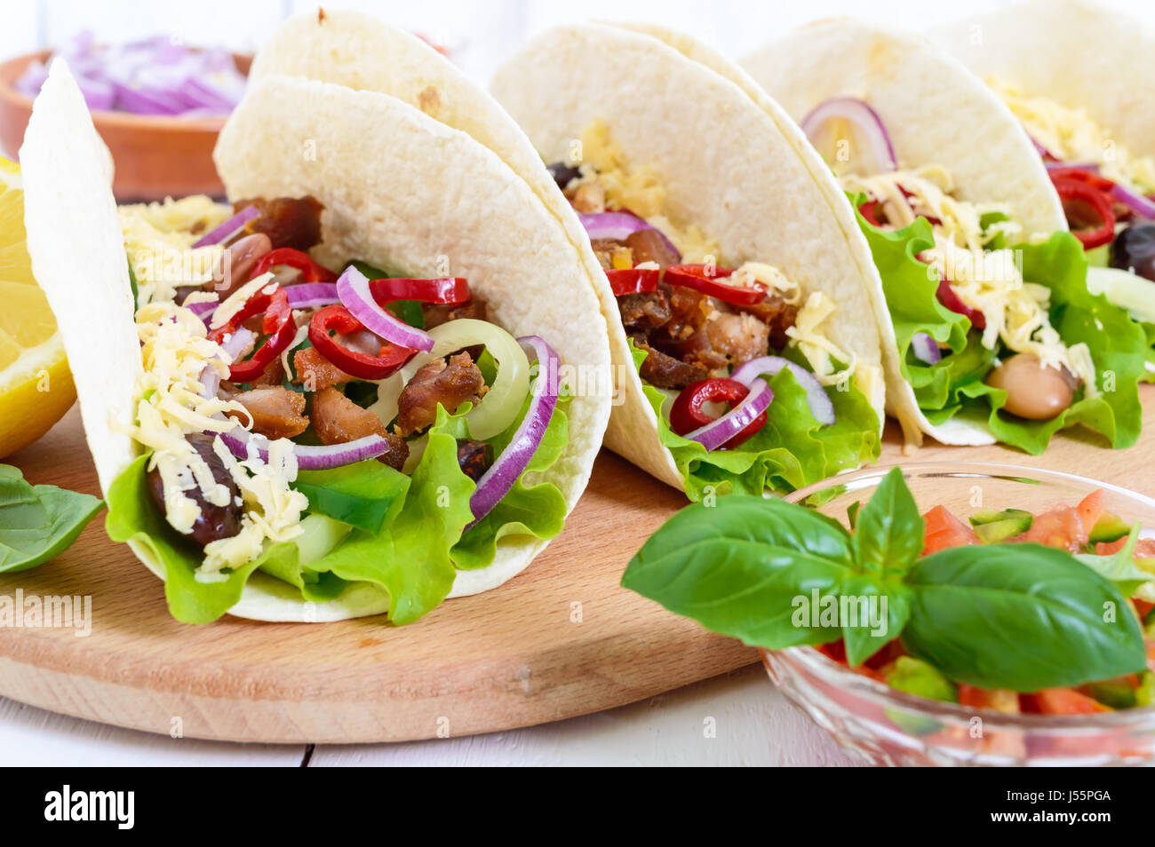 Tacos is a traditional Mexican dish. Tortilla stuffed with chicken ...