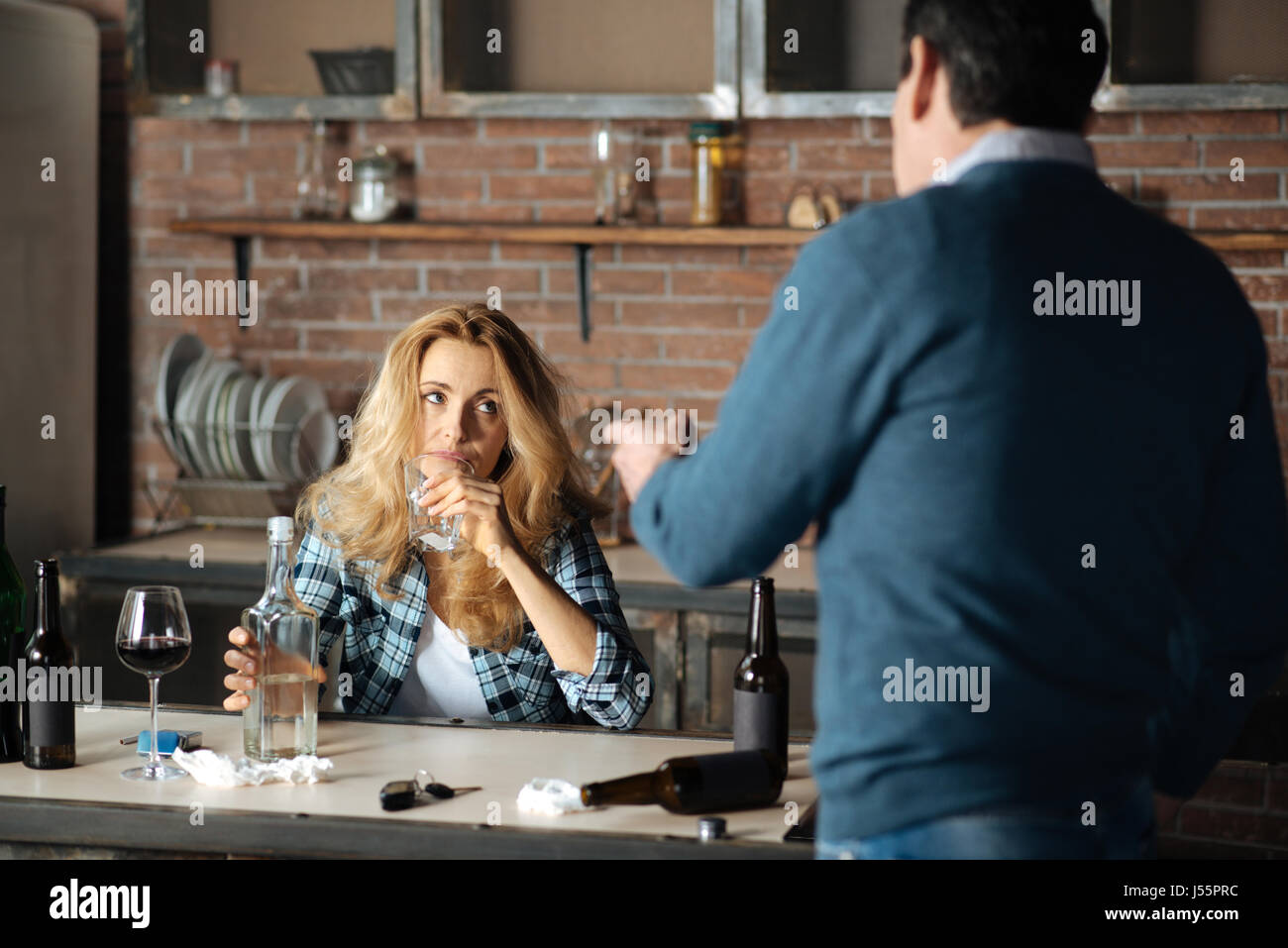 Indifferent woman looking upwards at her husband Stock Photo - Alamy