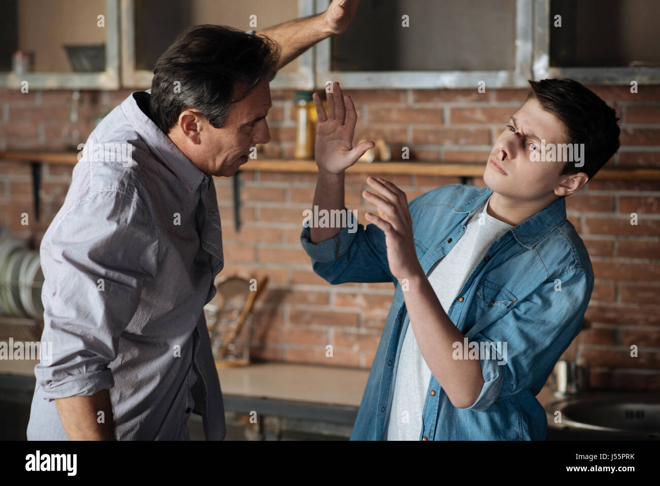 Scared beat teenager raising hands up Stock Photo - Alamy