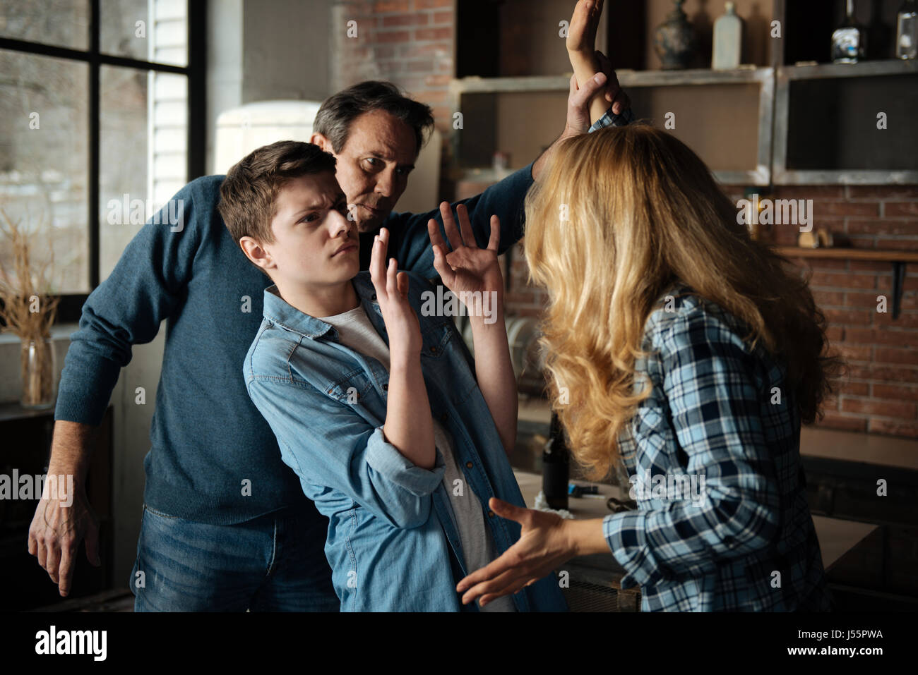 Strong man protecting his child from violence Stock Photo - Alamy
