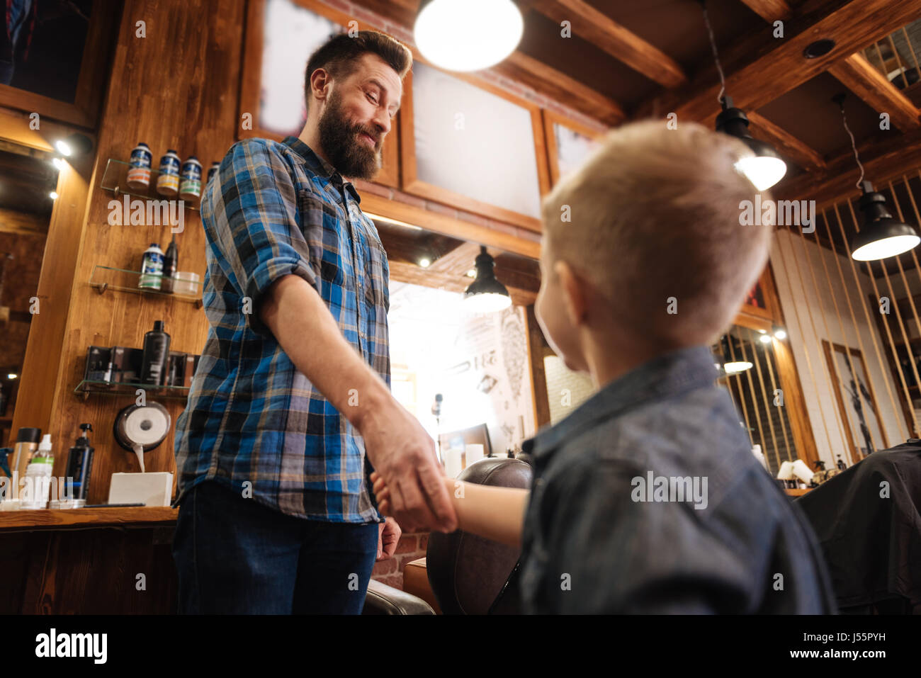 Happy friendly man looking at the boy Stock Photo - Alamy