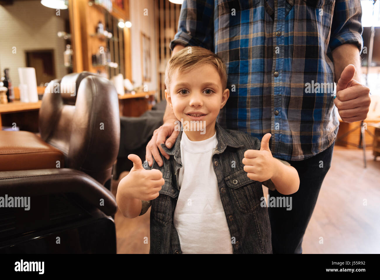 Cheerful delighted boy showing a thumbs up gesture Stock Photo - Alamy