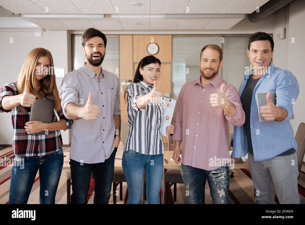 Group of happy people raising thumbs up Stock Photo - Alamy