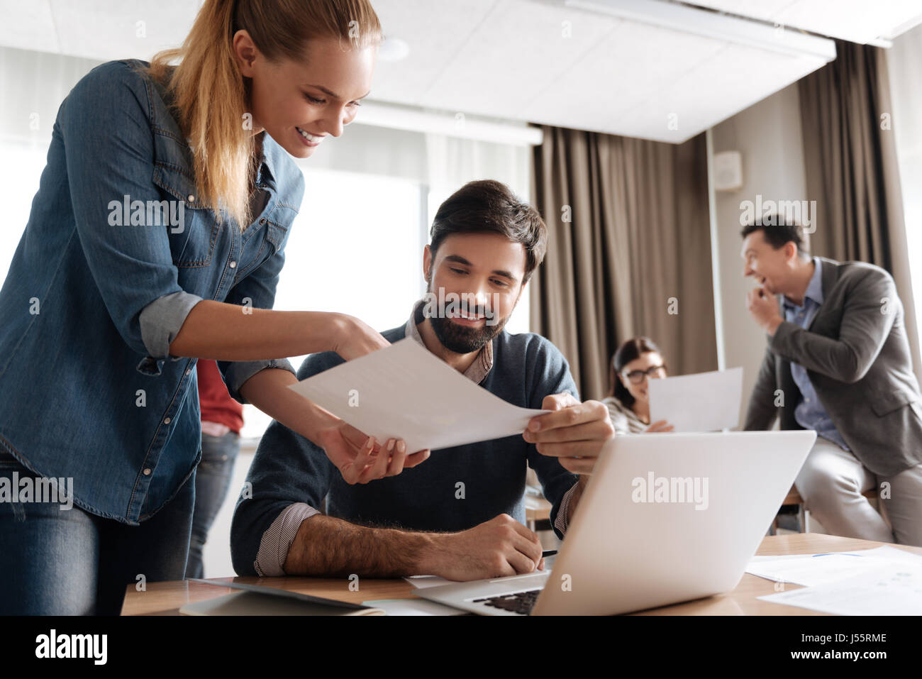 Handsome man taking sheet of paper Stock Photo - Alamy