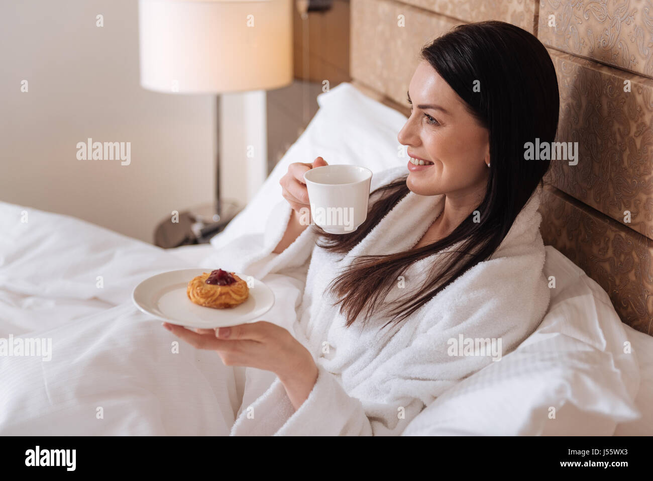Joyful happy woman lying in her bed Stock Photo - Alamy