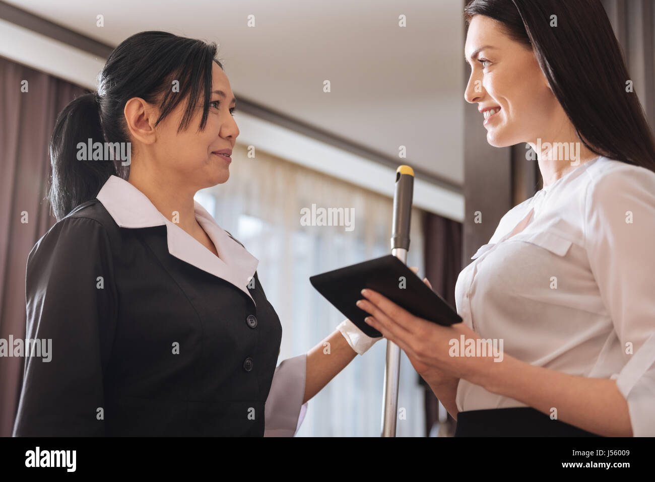 Happy positive women talking to each other Stock Photo - Alamy