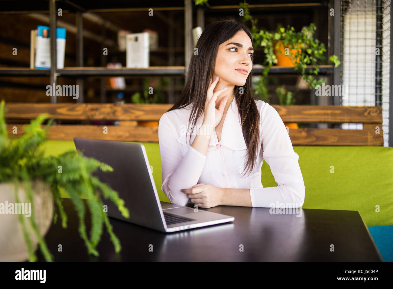 pretty young businesswoman using computer in office Stock Photo - Alamy