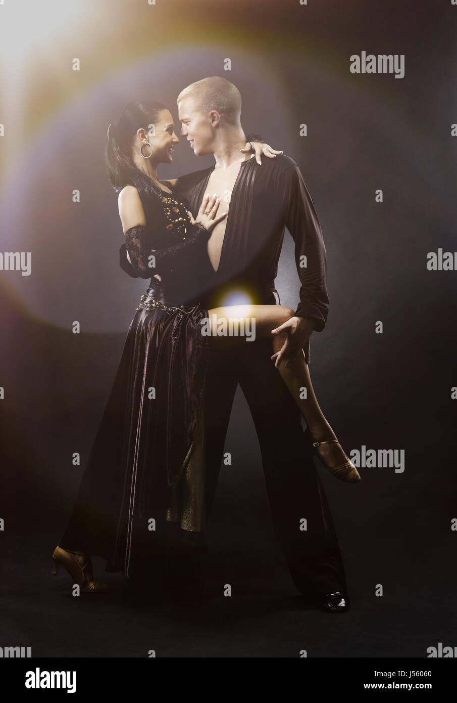 Latin dancers dancing in the glow of floodlights Stock Photo - Alamy