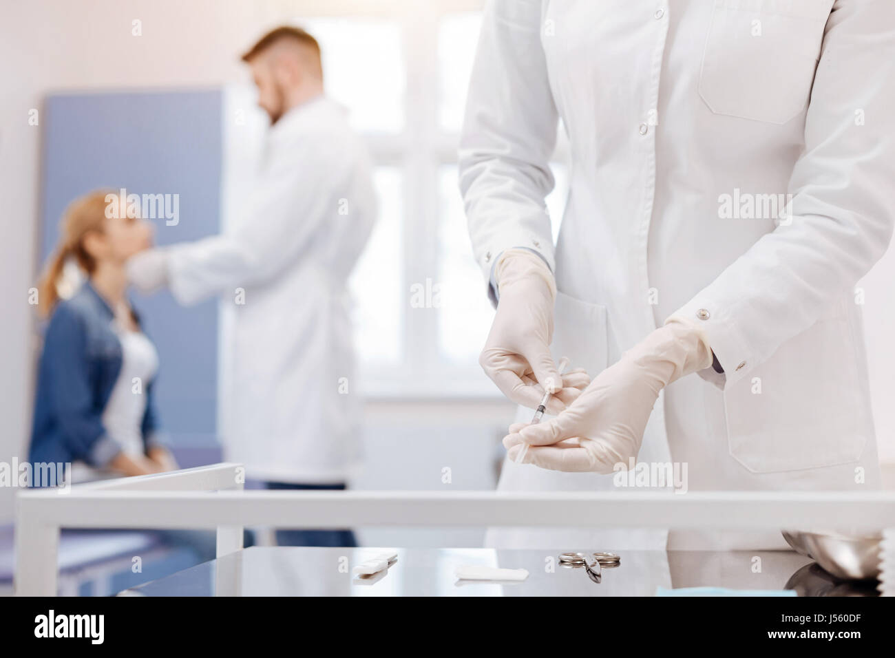 Nice professional doctor holding a syringe Stock Photo - Alamy