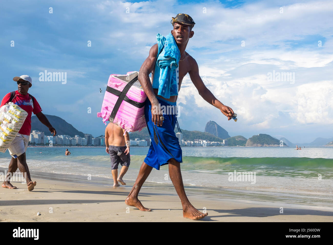 RIO DE JANEIRO - MARCH 2, 2017: Brazilian beach vendors walk along ...