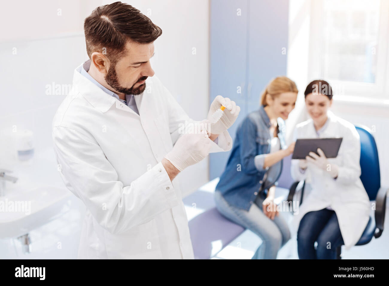 Doctor holding tablet bottle medicine hi-res stock photography and ...