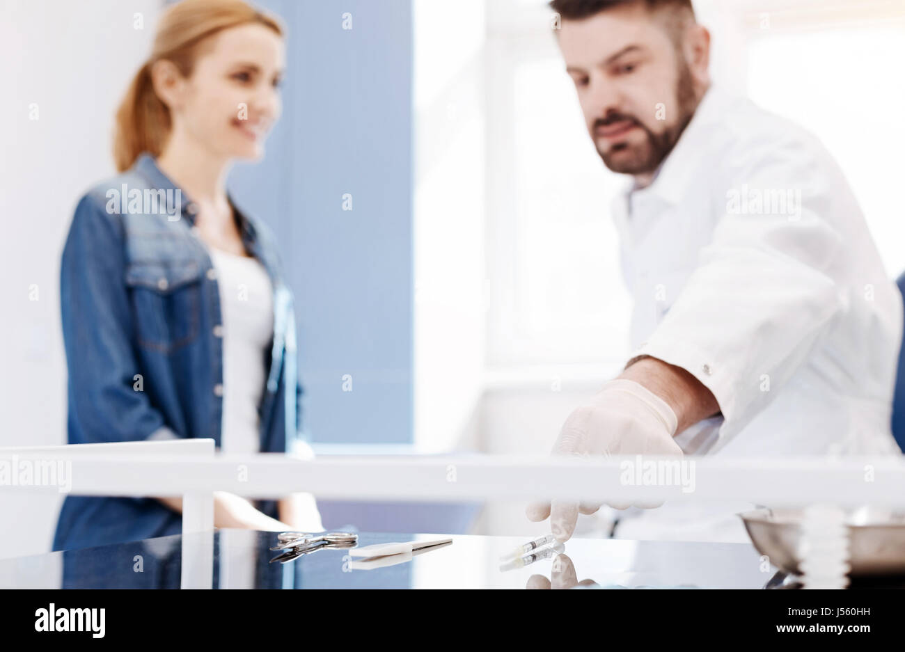 Nice male doctor taking a syringe Stock Photo - Alamy