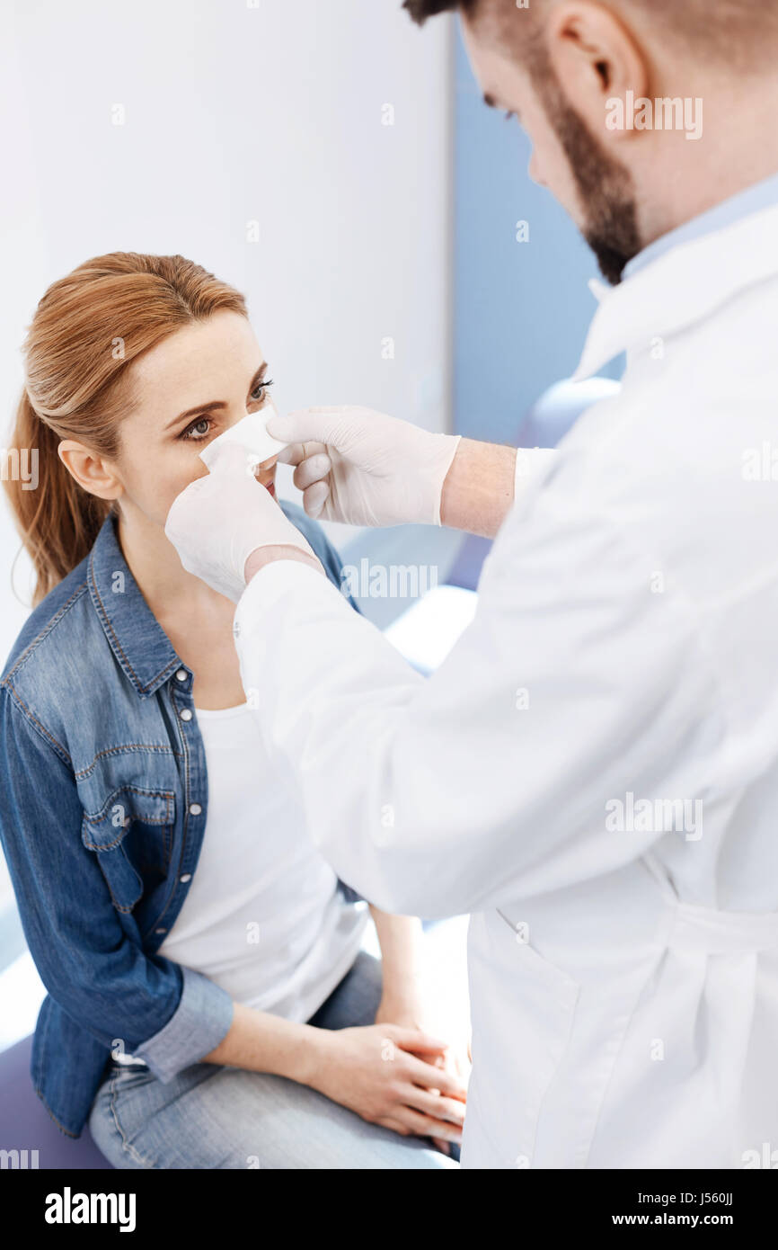 Professional experienced doctor looking at his patient Stock Photo - Alamy
