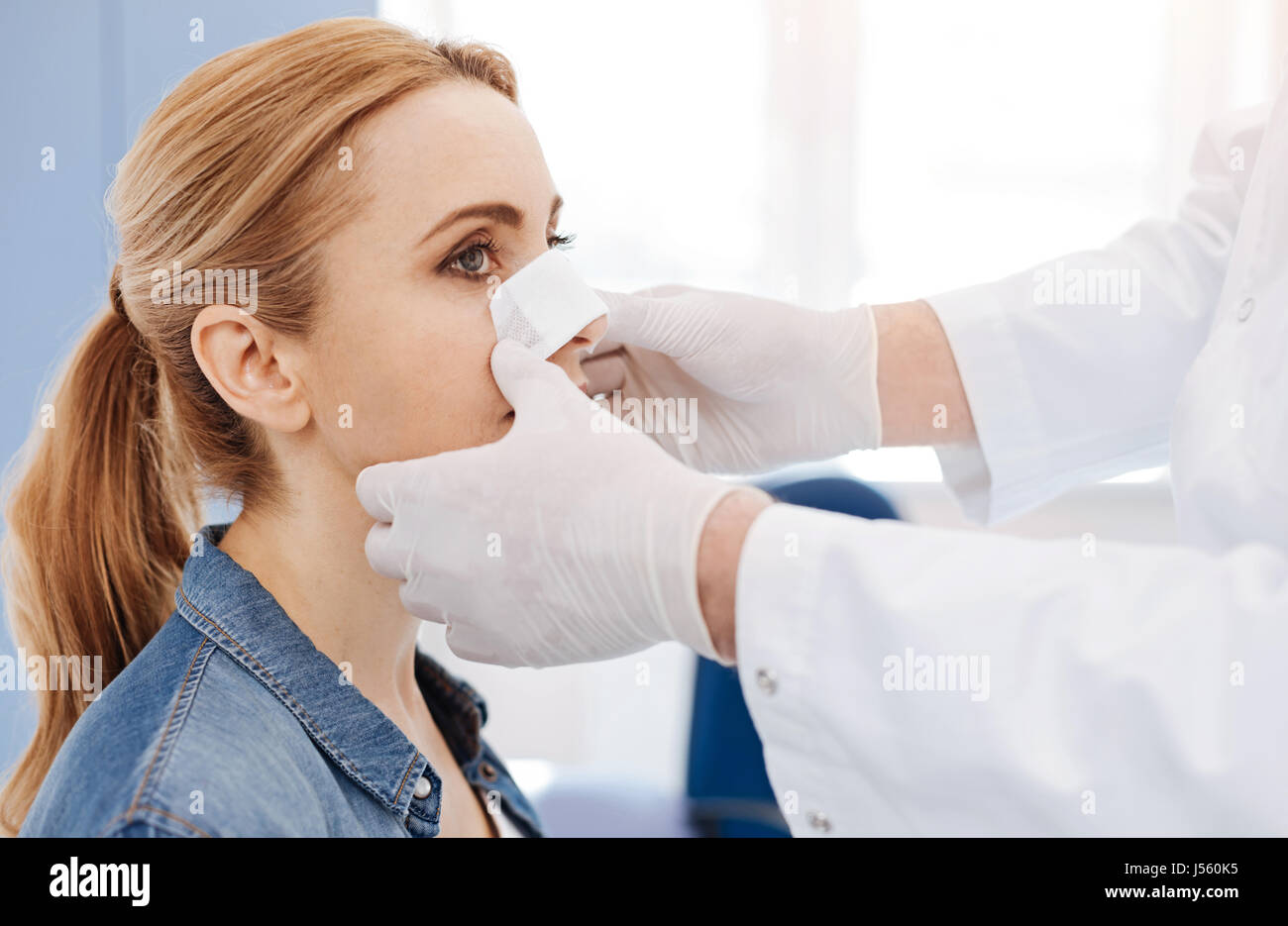 Nice male doctor putting a medical dressing Stock Photo - Alamy