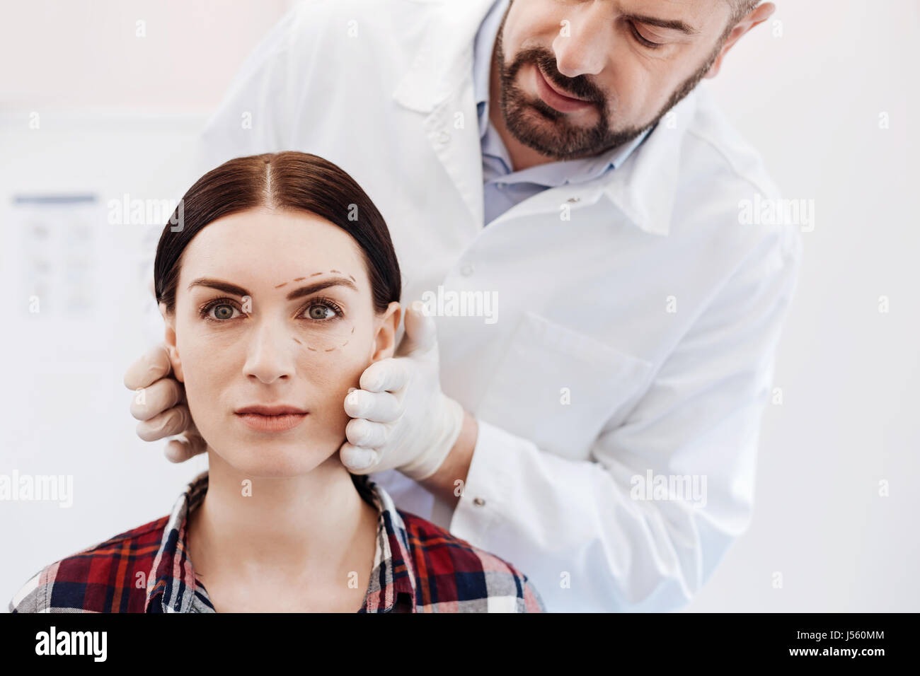 Handsome bearded doctor standing behind his patient Stock Photo - Alamy