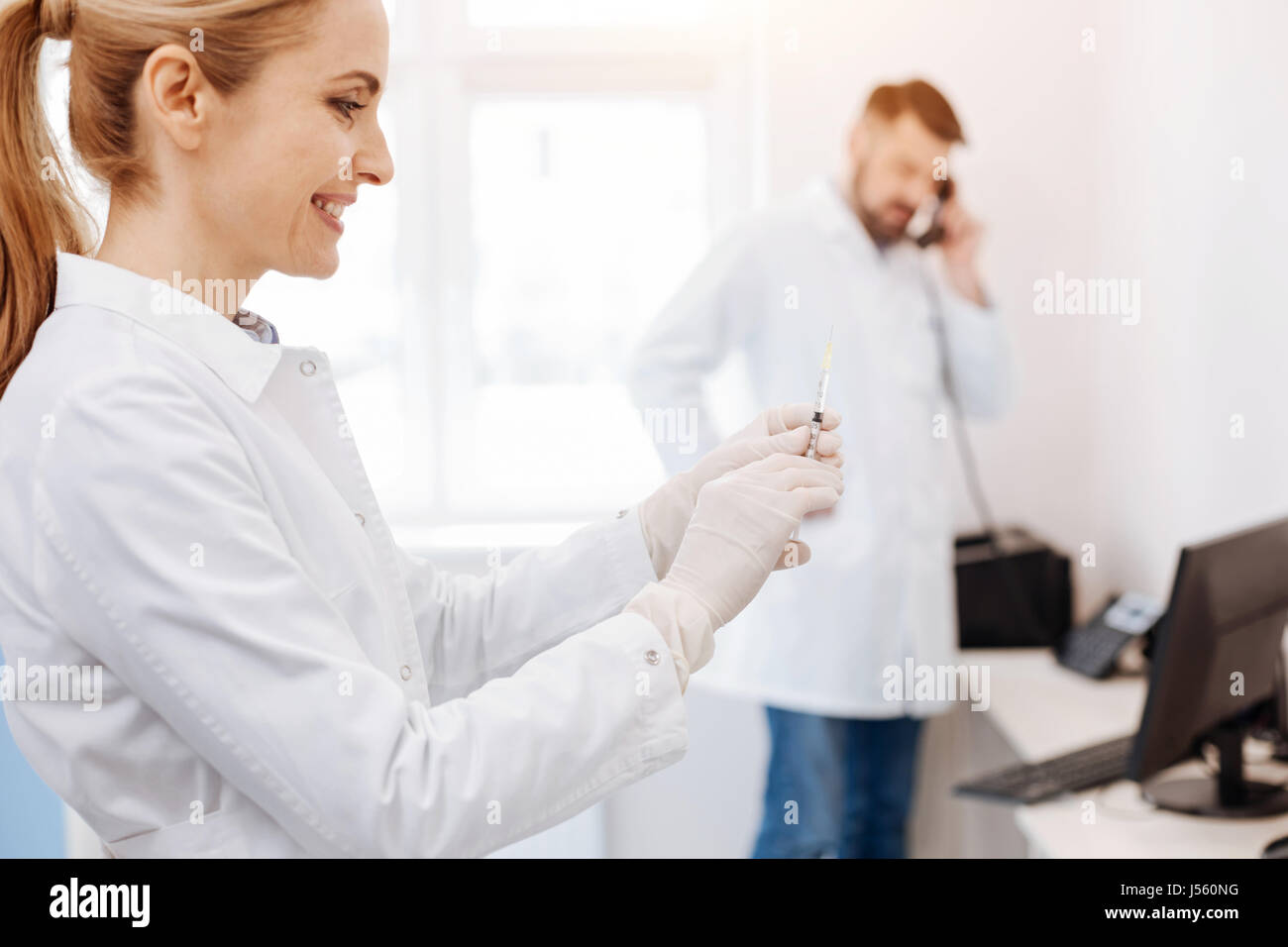 Happy delighted doctor preparing for injection Stock Photo - Alamy