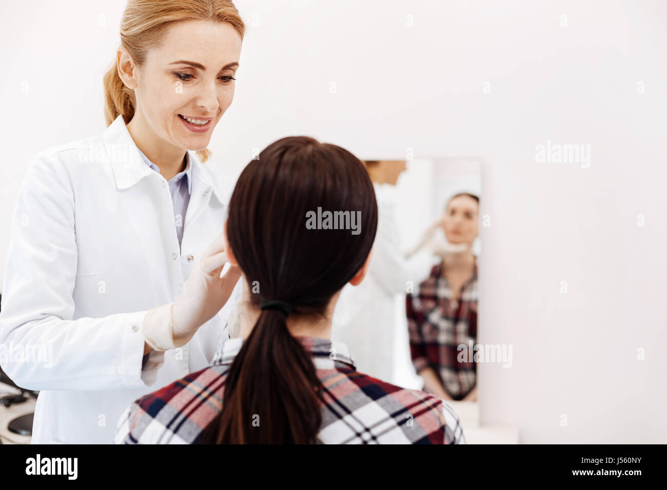 Delighted friendly doctor looking at her patients face Stock Photo - Alamy