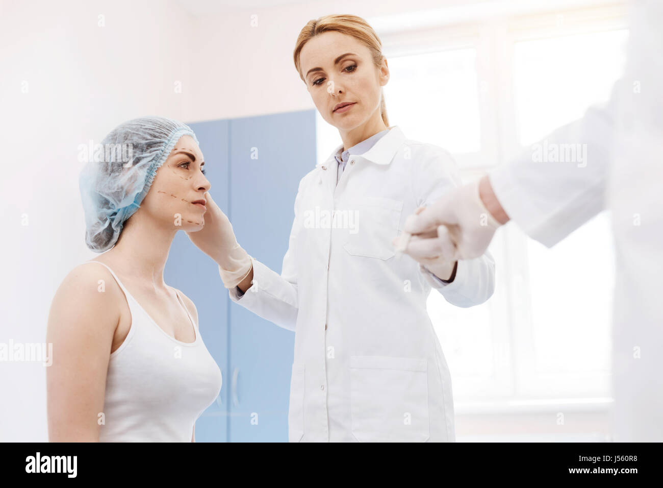 Female surgeon performing operation hi-res stock photography and images ...