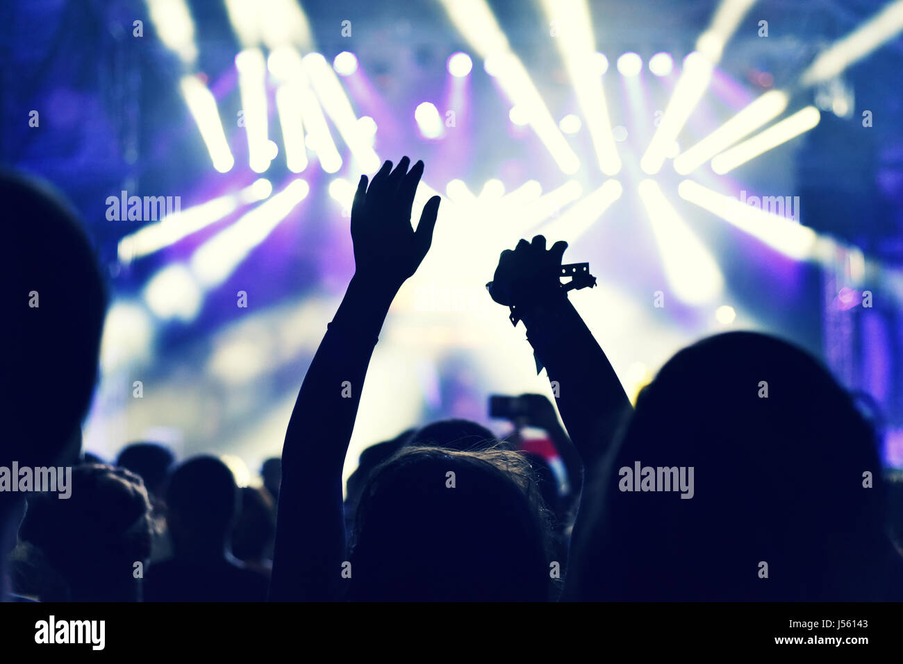 Silhouette of hands on a concert in front of bright stage lights Stock ...