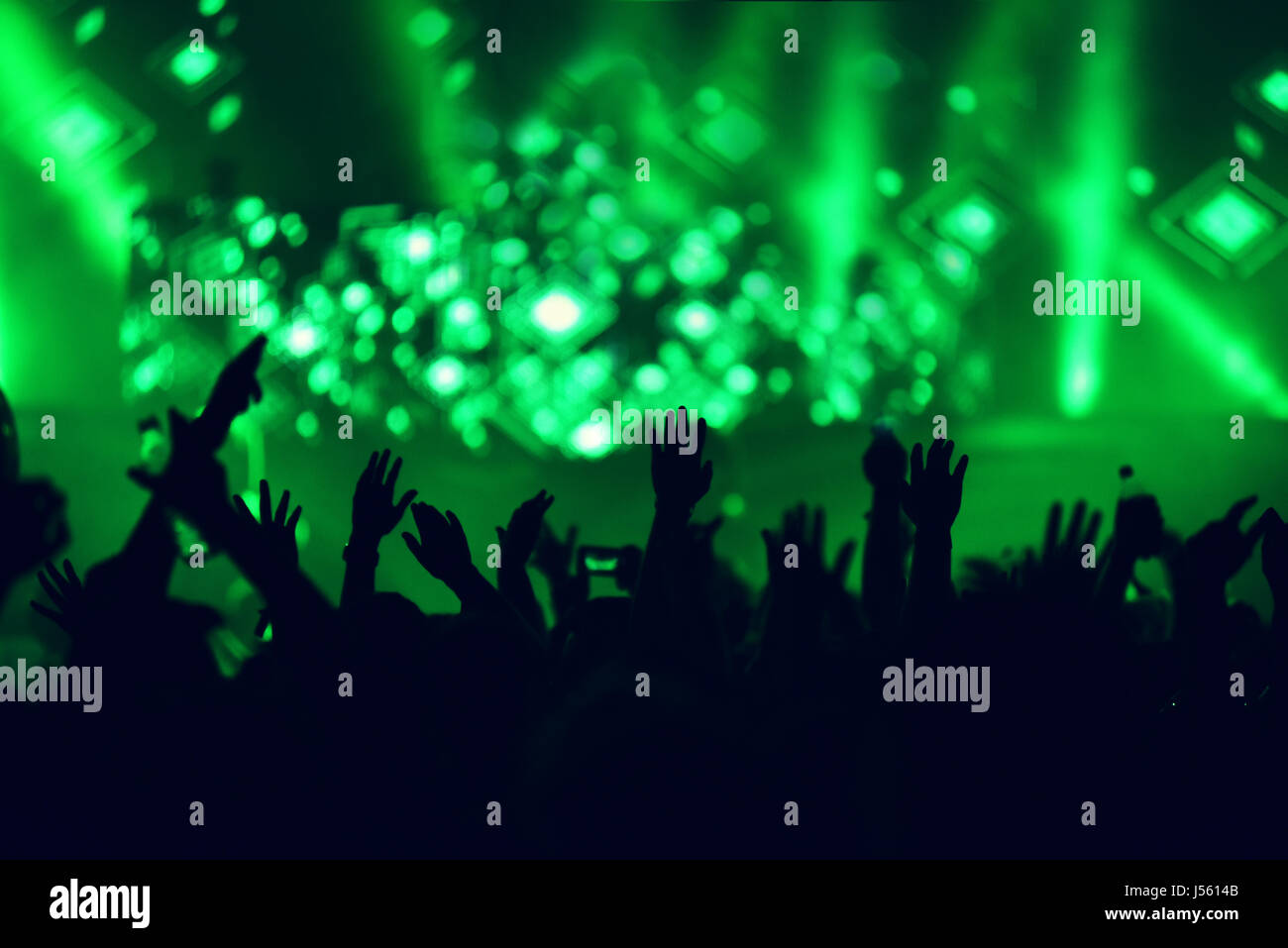 Silhouette of hands on a concert in front of bright stage lights Stock ...