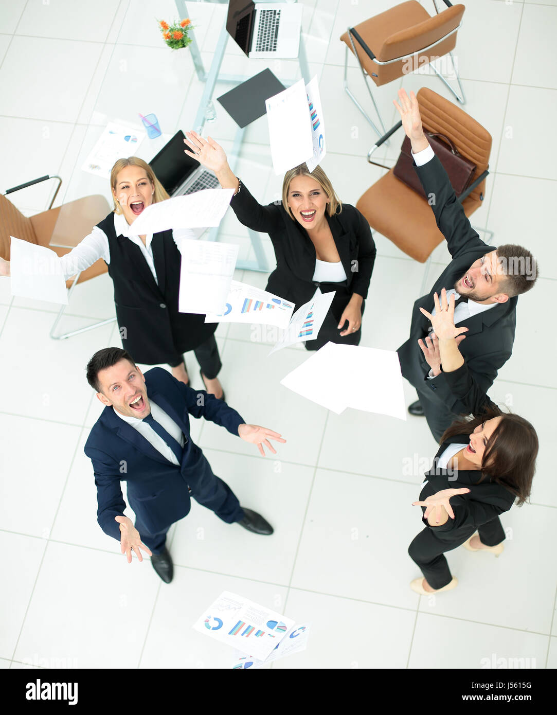 Happy business people throw into the air the documents Stock Photo - Alamy