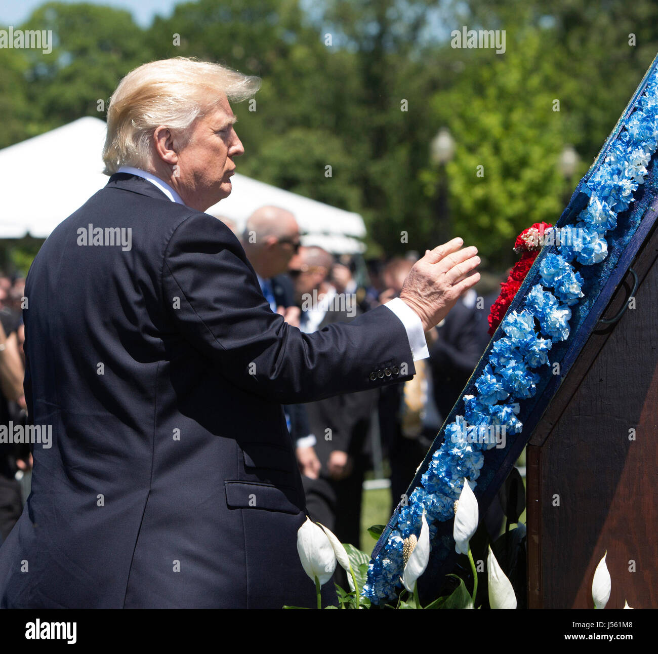 United States President Donald J. Trump places a flower on a memorial ...