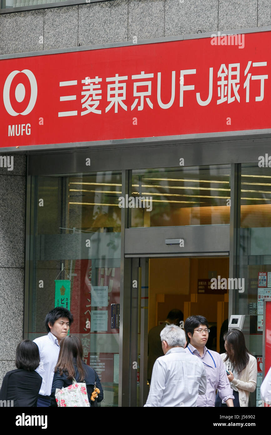 Tokyo, Japan. 17th May, 2017. Pedestrians walk past a signboard of Bank ...