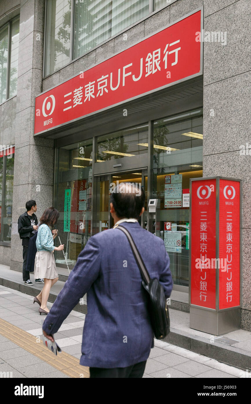 Tokyo, Japan. 17th May, 2017. Pedestrians walk past a signboard of Bank ...