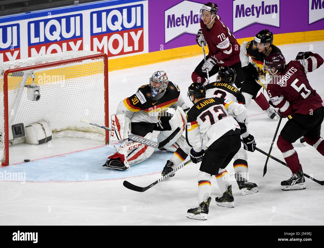 Latvia's Janis Sprukts (R) beats German goalkeeper Philipp Grubauer (L ...