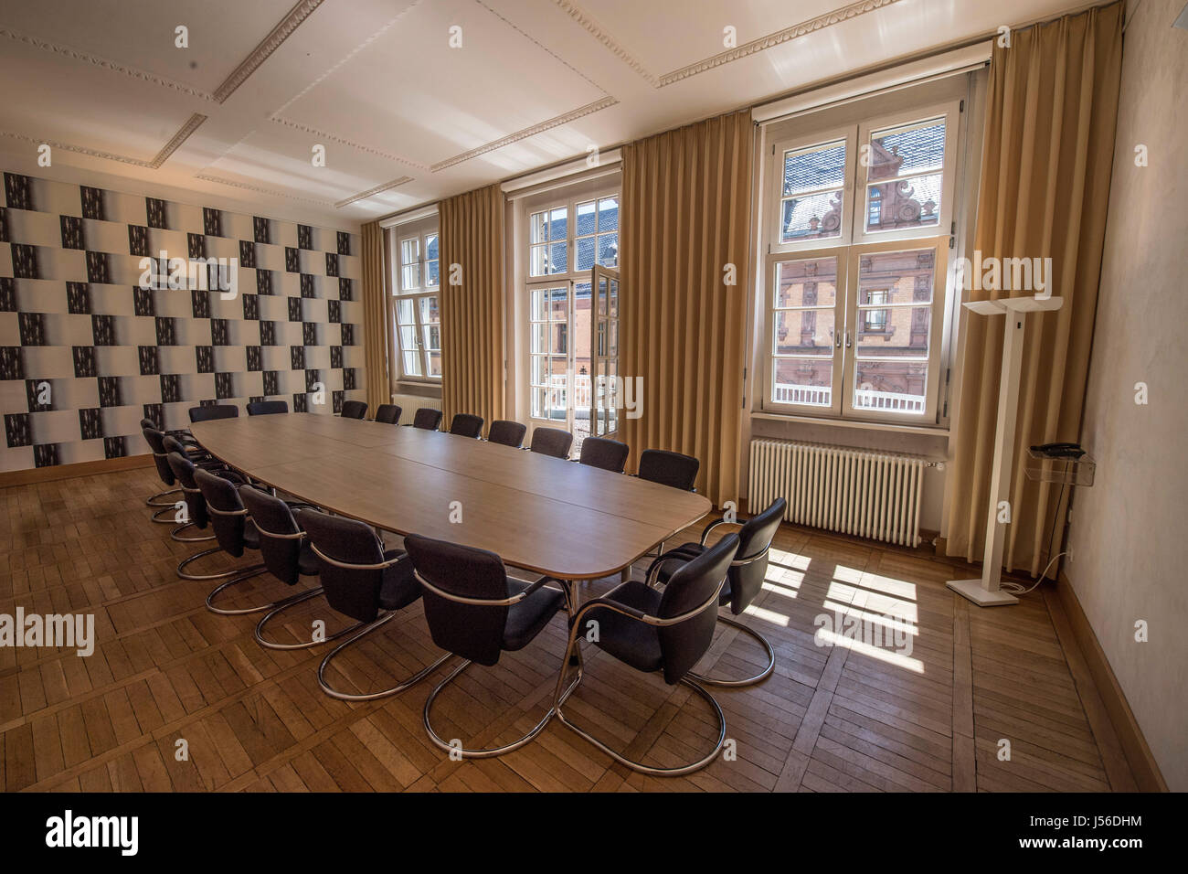 A conference table and a classical wallpaper command the former working ...