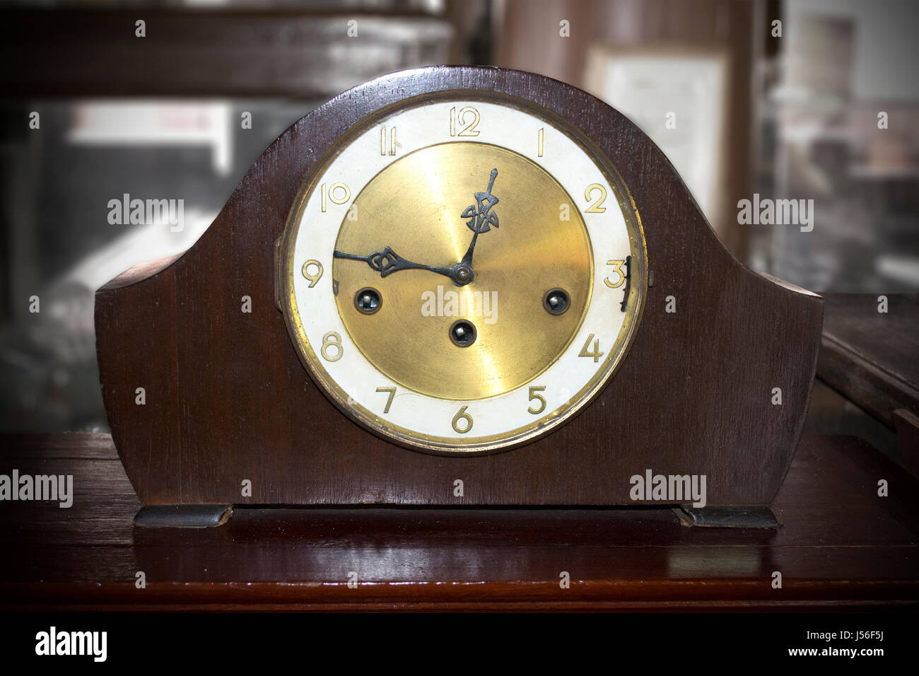 Wooden vintage clock on table at antique store Stock Photo - Alamy