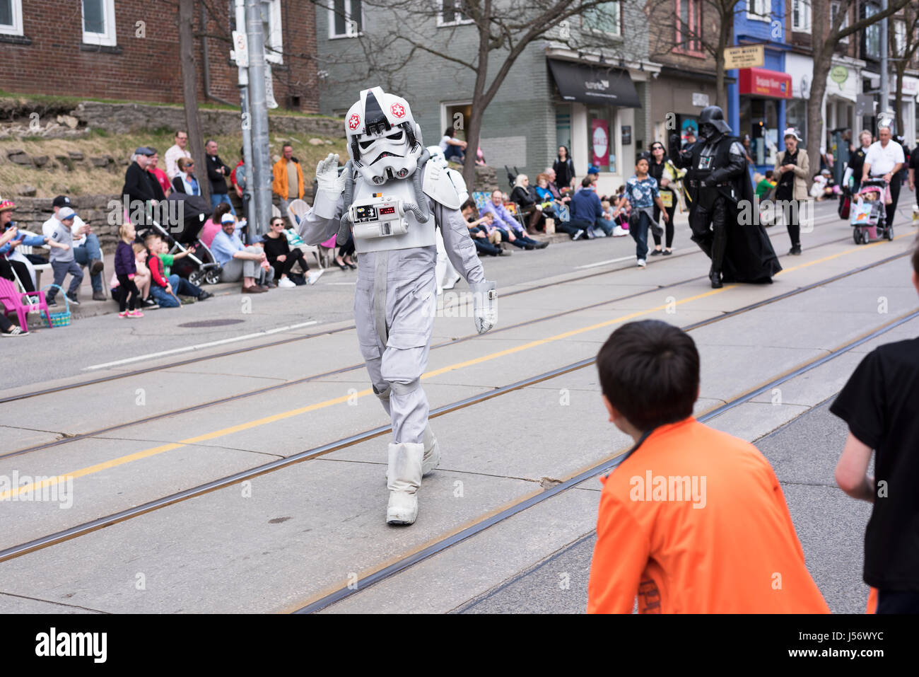 the Star Wars character Stormtrooper Pilot waves to children along the ...