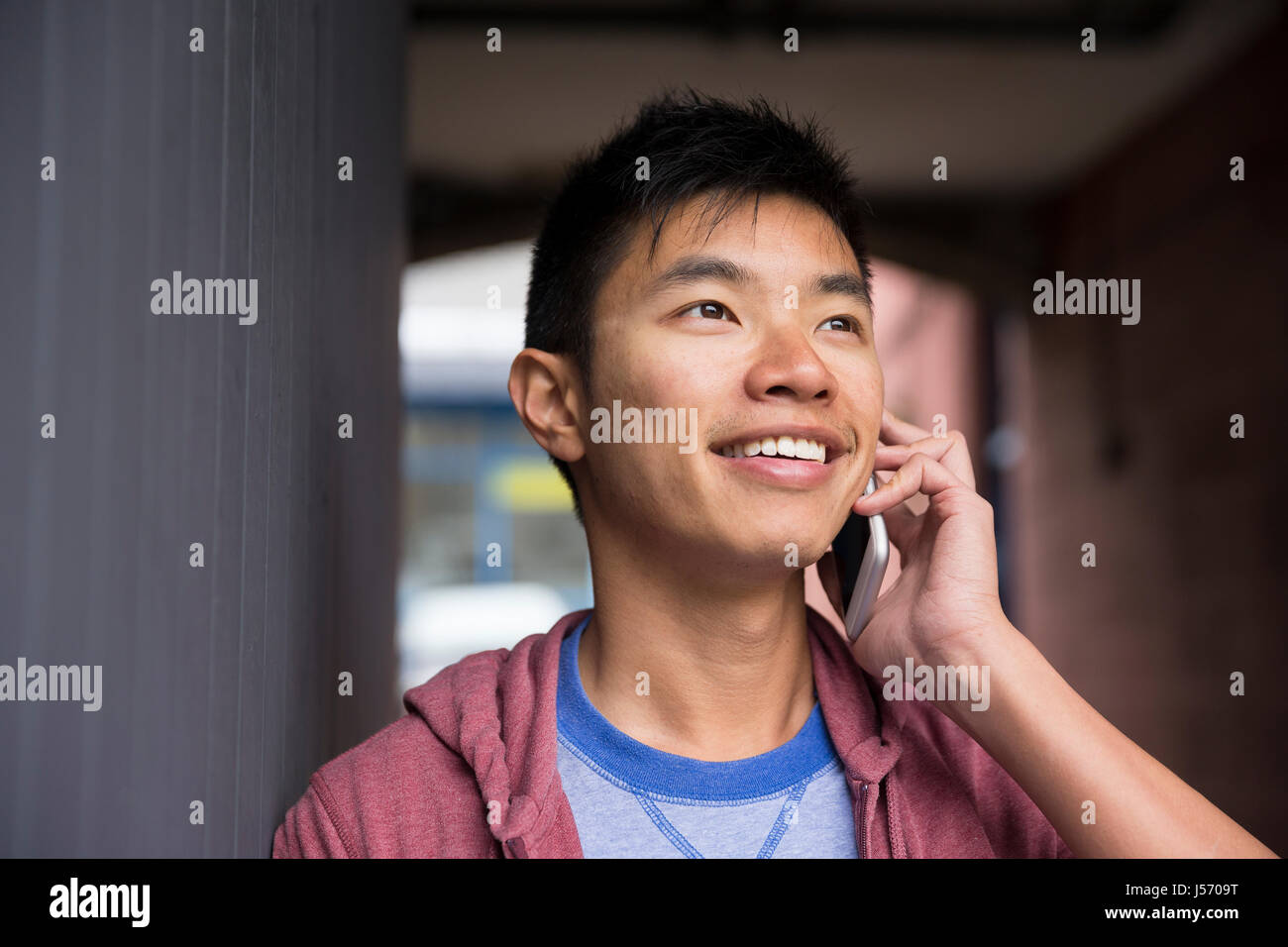 Chinese Man standing in city street using his Smart Phone Stock Photo ...