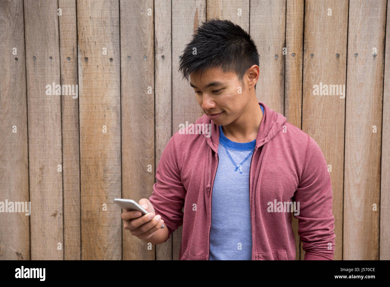 Chinese Man standing in city street using his Smart Phone Stock Photo ...