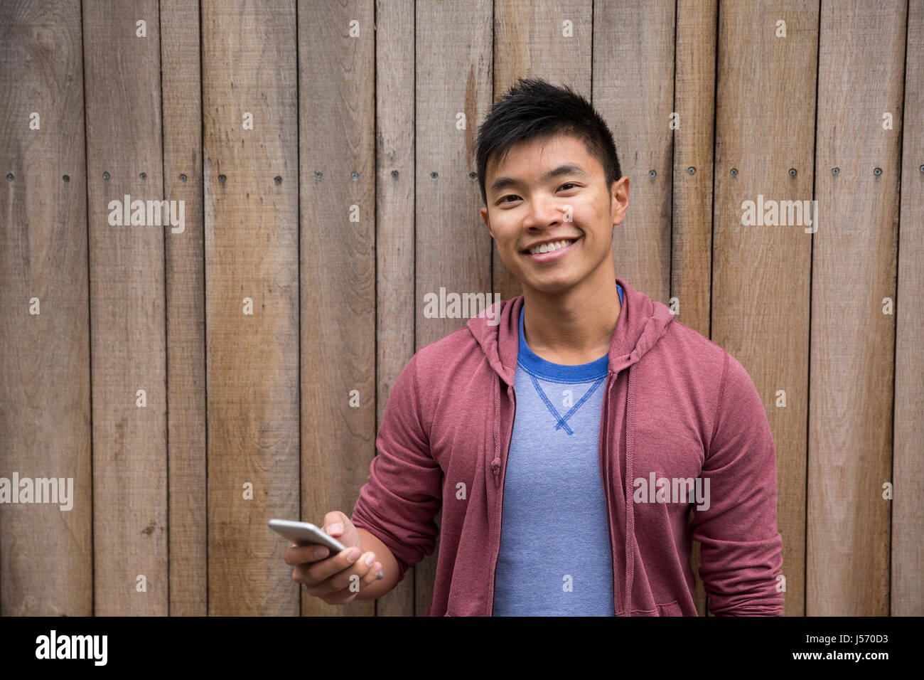 Chinese Man standing in city street using his Smart Phone Stock Photo ...